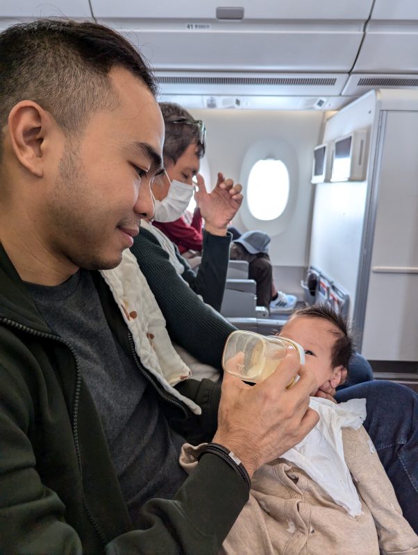 053_DadFeedsBabyinAirplane – Insta Photo Award – Photo Contest